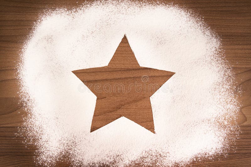 Star Shape Made with Cooking Flour on a Wooden Table. Stock Photo ...