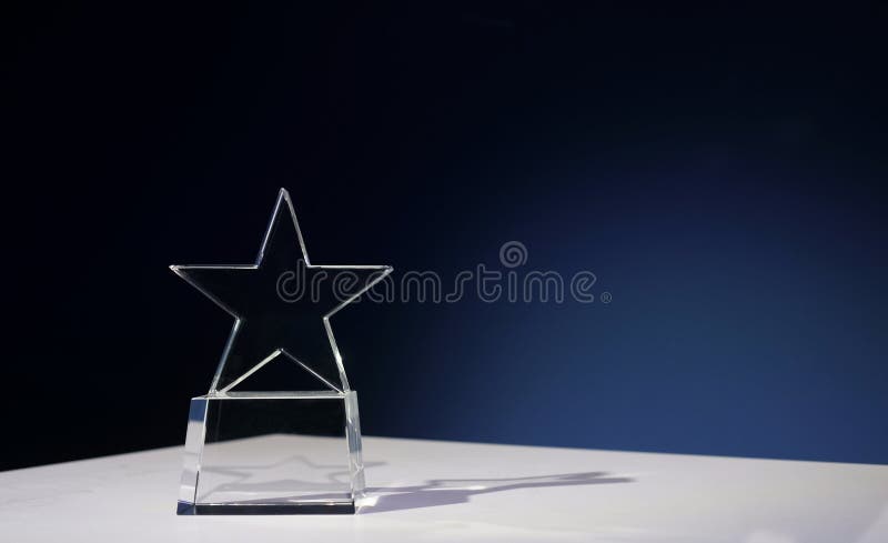 Star-shaped Award Made of Glass on a White Table Stock Photo - Image of ...