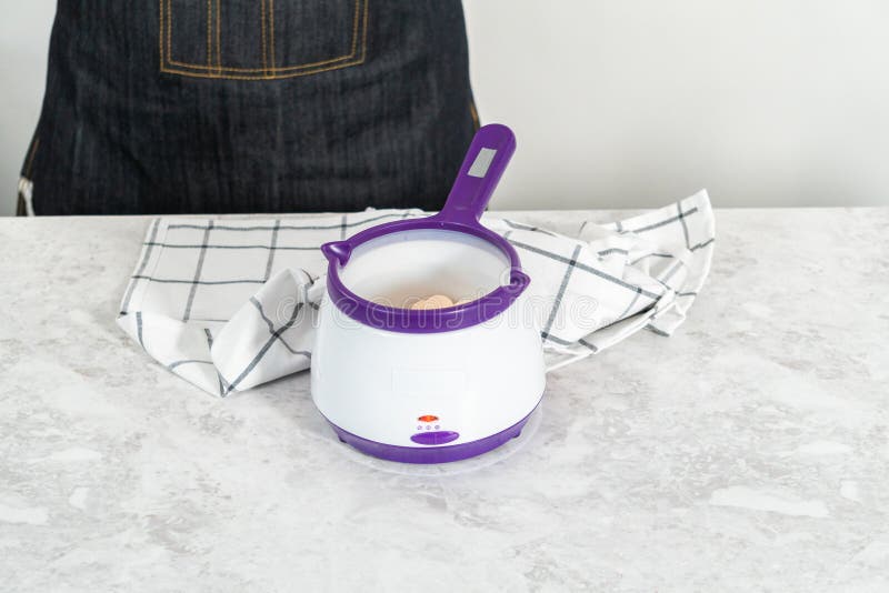 Melting Color Chocolate Chips in Electric Candy Melting Pot. Stock ...