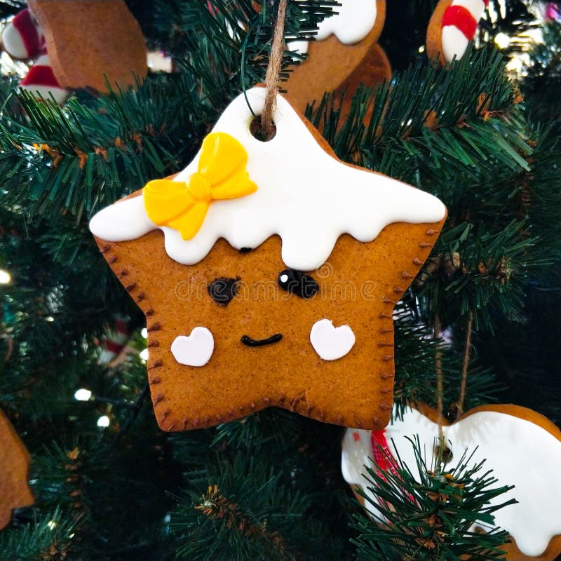 Star-shaped Gingerbread Cookie with a Yellow Bow Hanging on a Christmas ...
