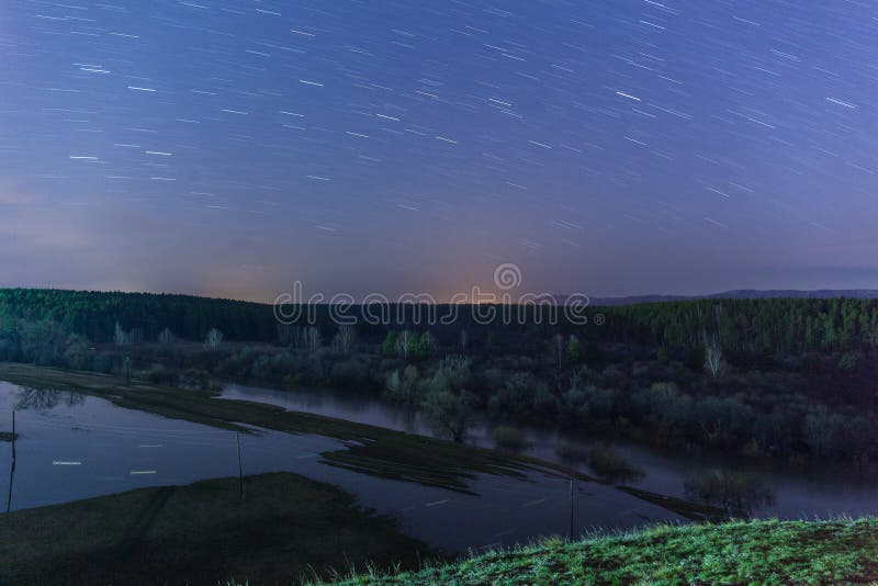 Star Traces are Reflected in the River during a Flood. Russia. Long ...
