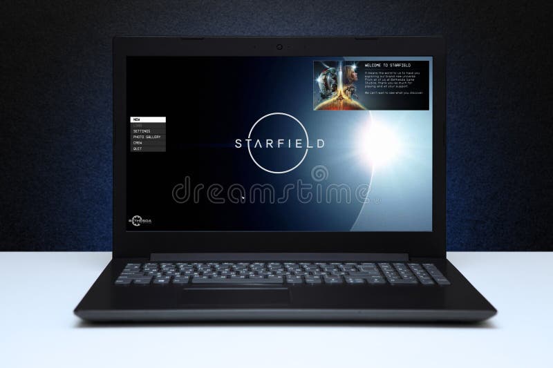 Starfield Game on the Screen Laptop Computer on Black Textured Wall ...