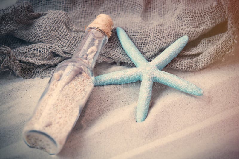 Starfish, Souvenir Bottle and Fishnet on the Sand Stock Photo - Image ...
