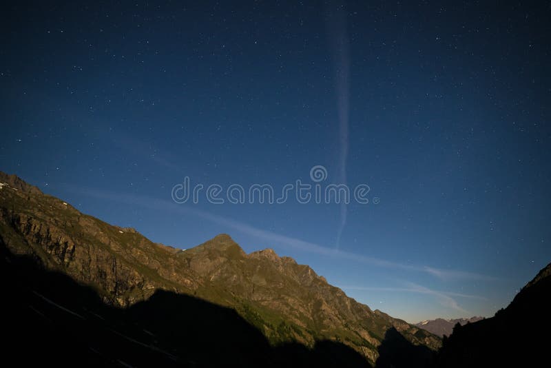 The Starry Sky on the Alps Illuminated by Moonlight. Expansive Night ...