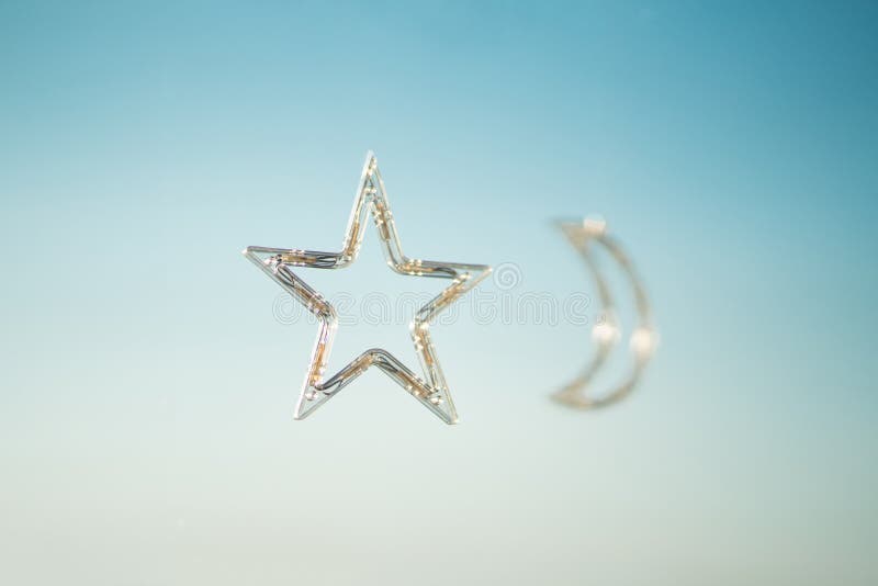 Stars and Half Moon Float on a Pastel Blue and White Background Stock ...