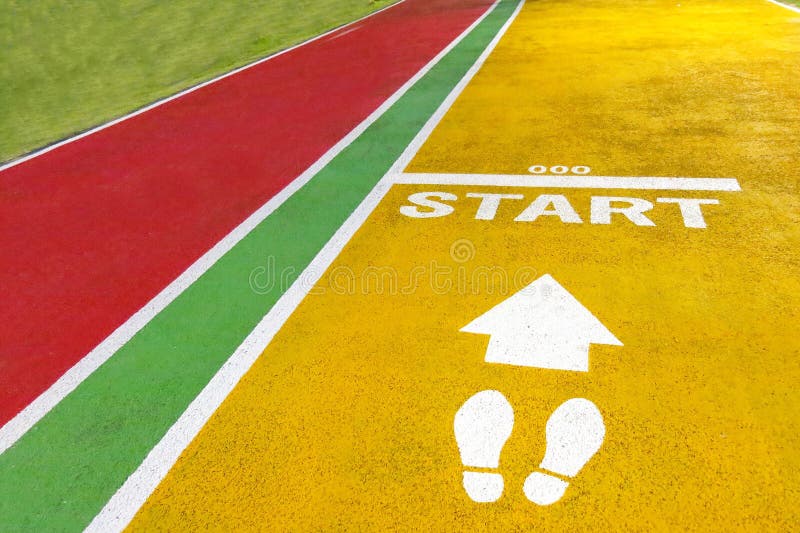 Red and Yellow Running Shoes on a Sports Field Stock Photo - Image of ...