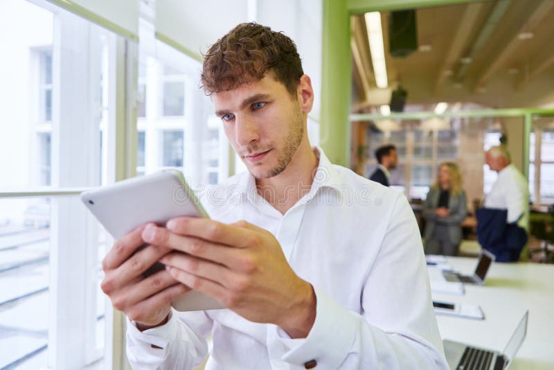 Start-up Founder Eagerly Reads the Message on the Tablet Stock Image ...