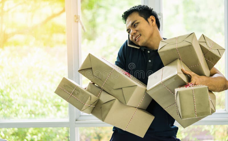 Businessman Working at Home Office Using Mobile and Holding Pack Stock ...