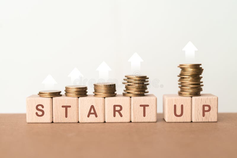START UP Text on Wooden Cube Blocks with Stack of Coin and Up Arrow ...