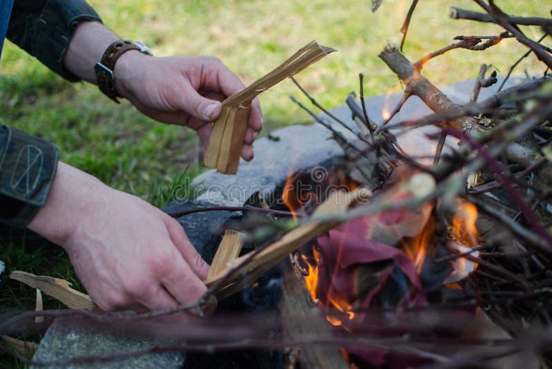 Man Starting A Campfire Blowing On A Fire Stock Photo - Image of ...