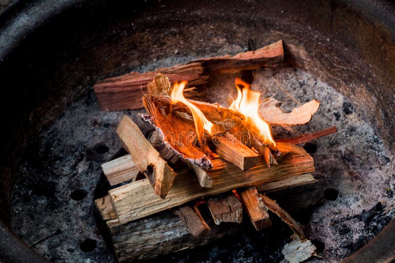 Starting a Campfire in a Firepit with Kindling. Camping Lifestyle Stock ...