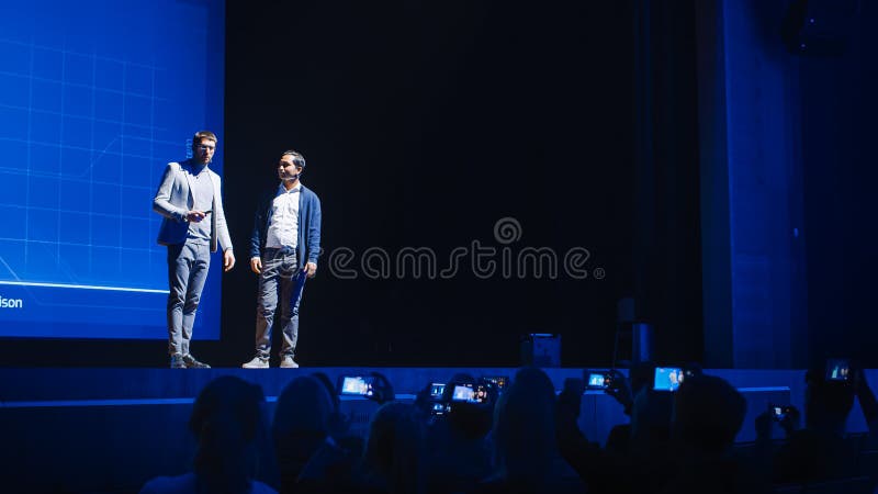 Startup CEO and Chief Developer Stand on Stage and Present New Product ...