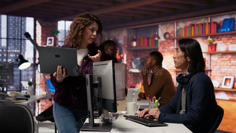 AI Startup Intern Holding Laptop Asks Questions To Senior Technician Stock Video - Video of ...