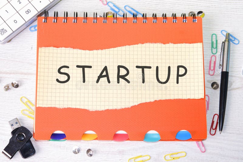 Startup - Word Concept on a Piece of Paper on an Orange Notebook Stock ...