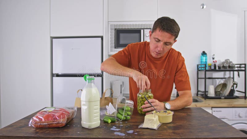 A Very Hungry Starving Man Quickly Eats Groceries Food in a Modern ...