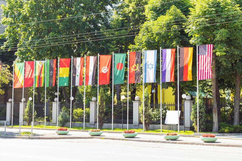 State Flags of Different Countries on Flagpole in a Row Waving in the ...