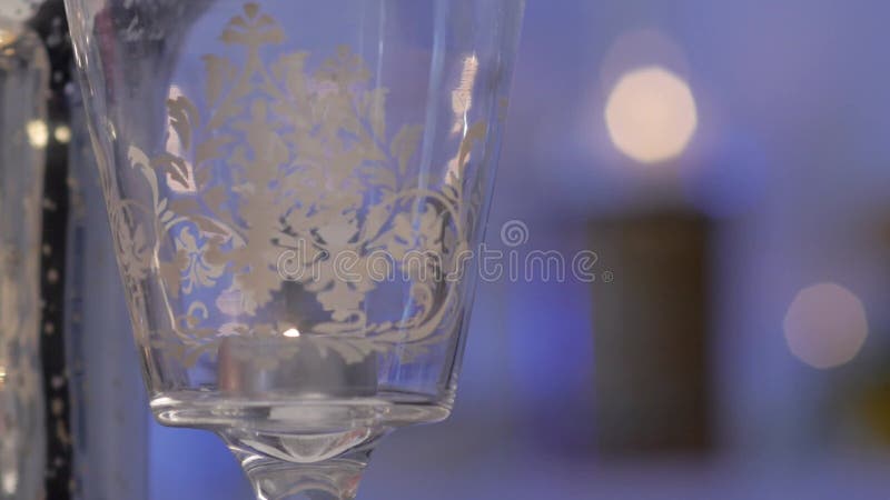 The Candle Burns Inside a Glass Container with Luxurious Engravings ...