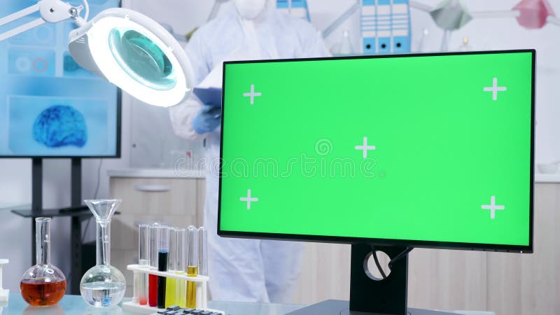 Static Shot of Chemist Desk with a Green Screen Mock-up Desktop PC ...