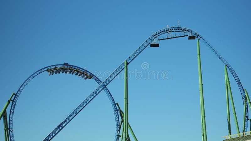 A Roller Coaster Ride Passing through a Dead Loop Turning Passengers ...