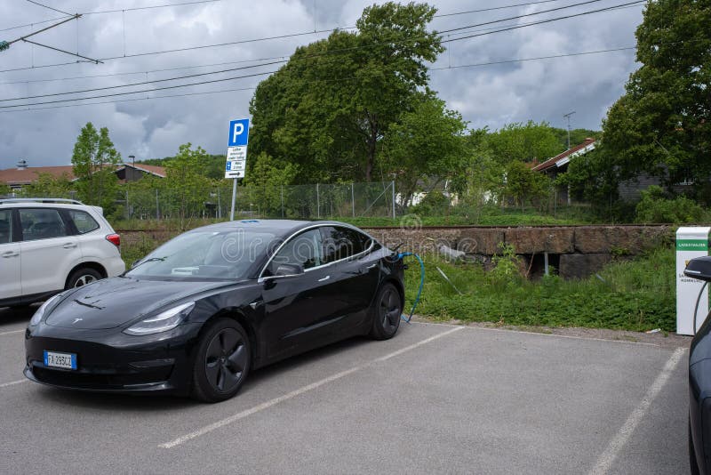 A Static Shot of a Solid Black Tesla Model 3 Dual Motor Charging at the ...