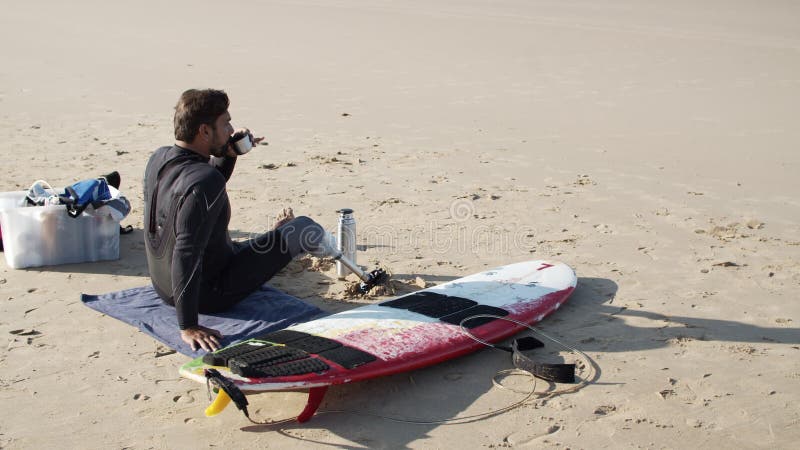 Static Shot of Surfer with Disability Drinking Tea on Beach Stock Video ...