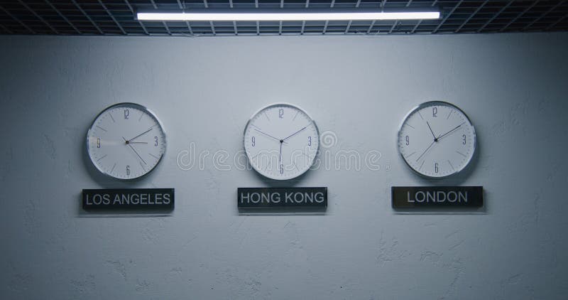 White Wall Clocks Illuminated by Lamp in Office Stock Image - Image of ...