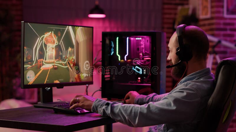Static Tripod Shot of Man Using Pc Setup Playing Multiplayer Online ...