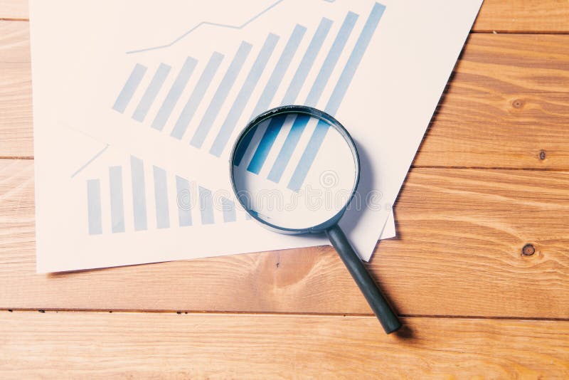 Statistics and magnifier stock image. Image of graph - 216704165
