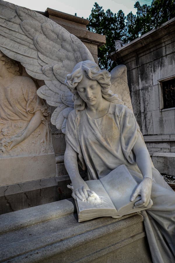 Statue of Angel Reading Next To a Pantheon Stock Image - Image of grave ...