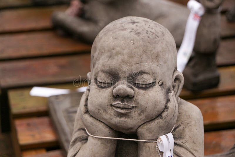Statue of a Baby at a Garden Centre Stock Photo - Image of bald, mouth ...