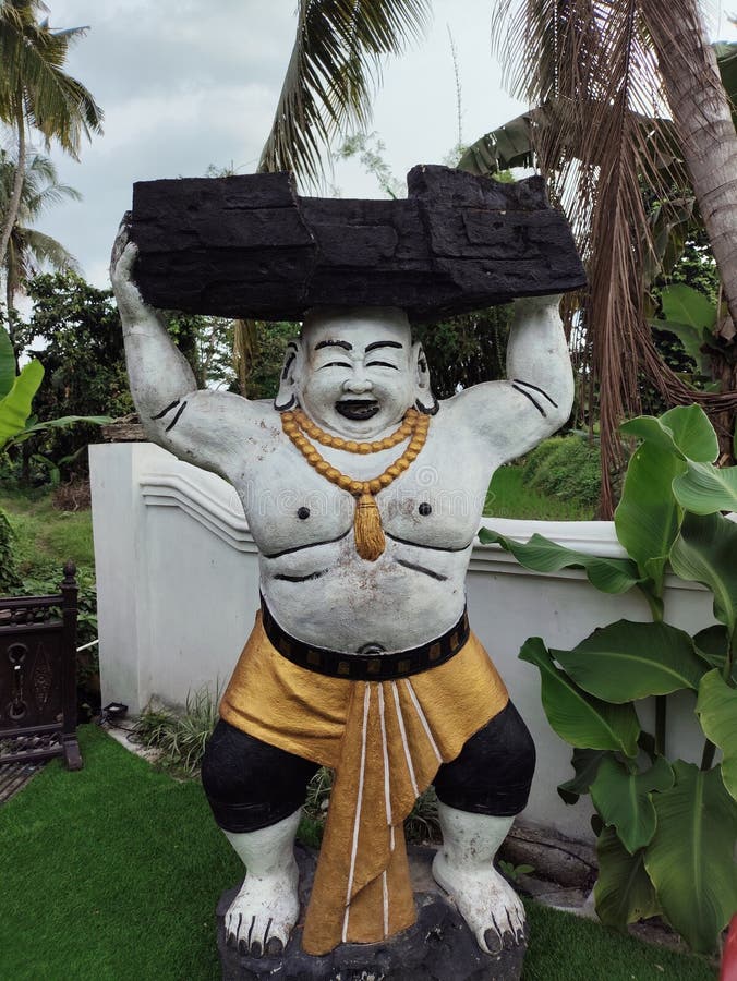 A Statue of a Fat Man Carrying a Stone Editorial Photography - Image of ...