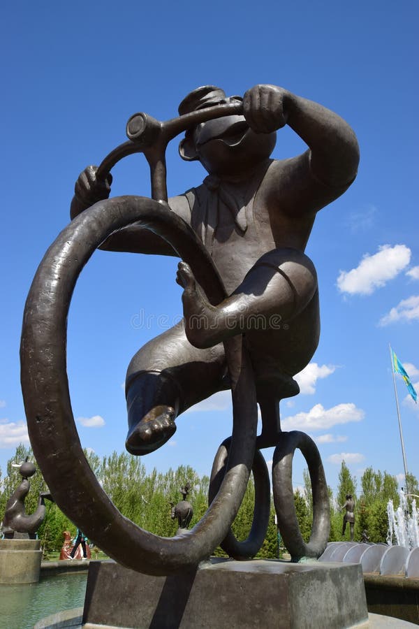 A Statue Featuring a Monkey Riding a Circus Bicycle Editorial Stock ...
