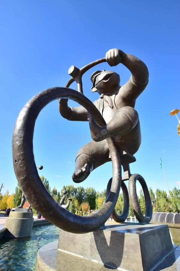 A Statue Featuring a Monkey Riding a Circus Bicycle Editorial Stock ...