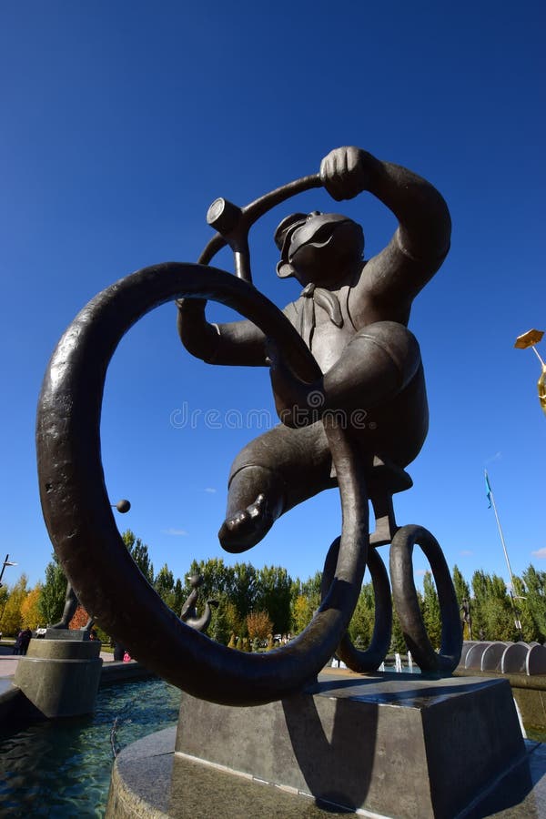 A Statue Featuring a Monkey Riding a Circus Bicycle Editorial Stock ...