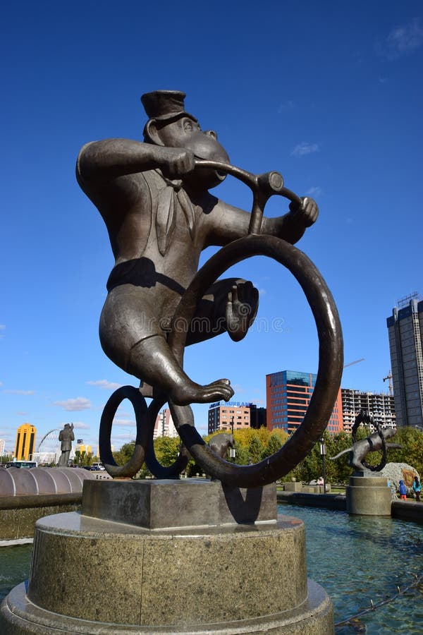 A Statue Featuring a Monkey Riding a Circus Bicycle Editorial Stock ...
