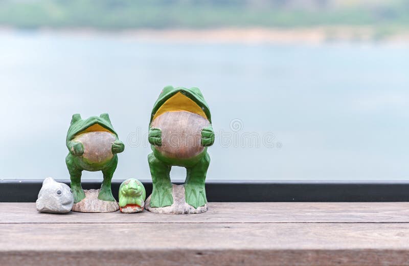 A Statue of a Frog on a Wooden Table Stock Photo - Image of decorative ...