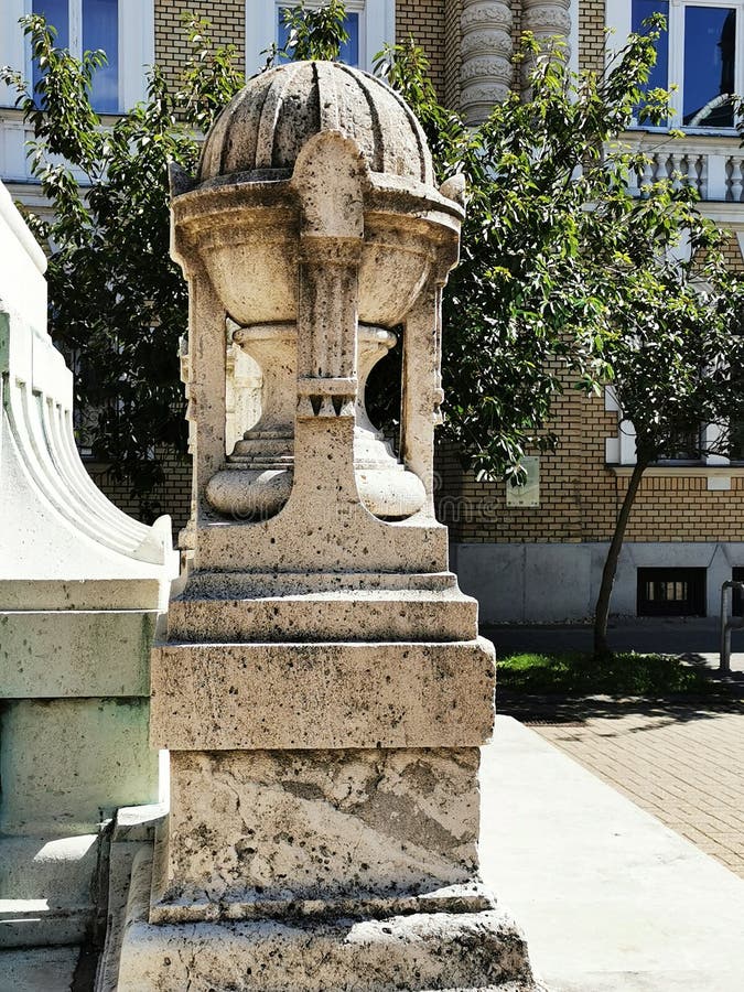 A Statue In Front Of A Brick Building Stock Image - Image of side ...