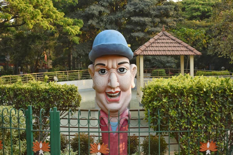 A Statue of a Funny Looking Man Wearing a Cap, in a Park Editorial ...