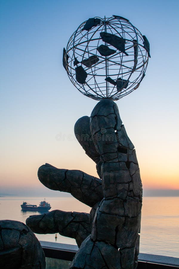 Statue with a Hand Holding the World at Sunrise Editorial Photo - Image ...