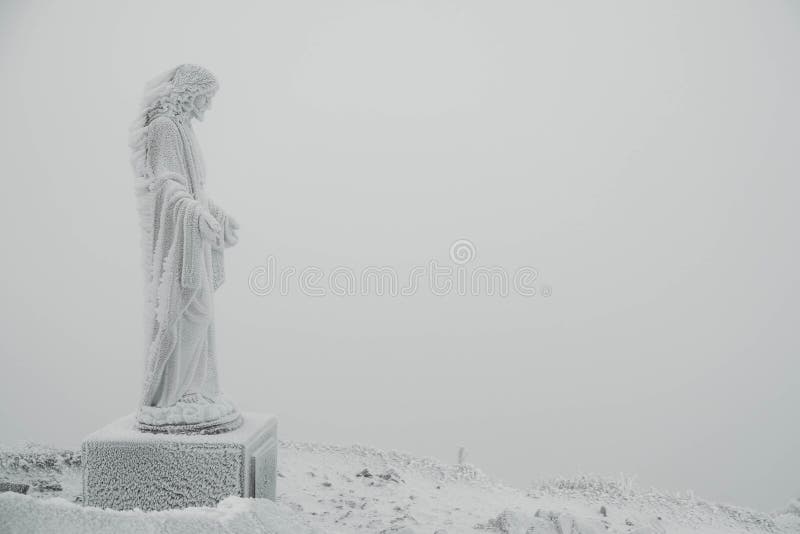 The Statue of Jesus is Covered with Snow and Ice on Top of the Mountain ...