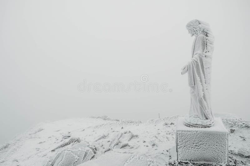 The Statue of Jesus is Covered with Snow and Ice on Top of the Mountain ...