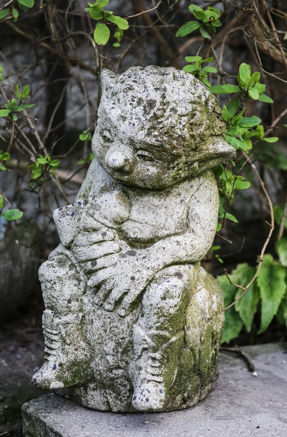 Statue Of A Little Imp From A Yellow Stone Stock Image - Image of smile ...