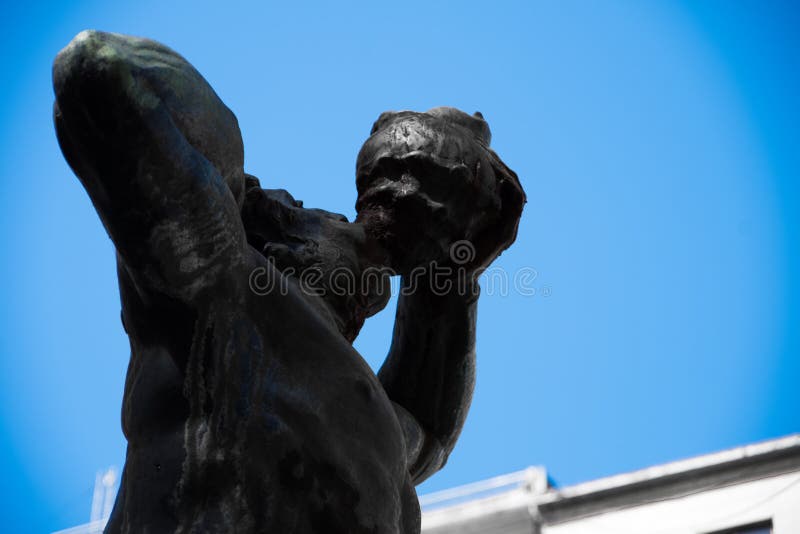 Statue of a Man with a Horn Looking Up Stock Image - Image of blowing ...