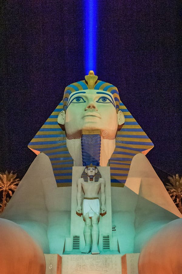 A Statue of a Man and a Statue of a Woman are in Front of a Pyramid ...