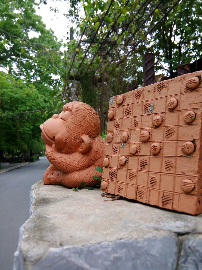 Statue of Monkey Playing Checkers Stock Image - Image of flower, rock ...