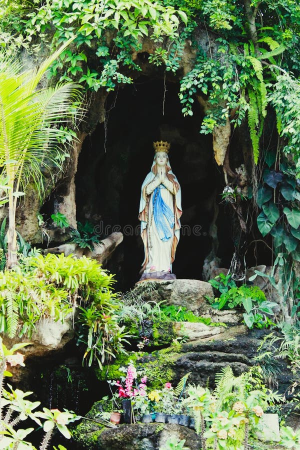 A Statue of Mother Mary in a Grotto Stock Image - Image of catholic ...