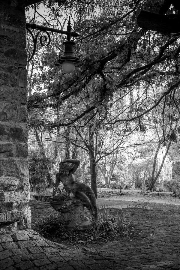 Statue of a Nymph in a Garden Setting Stock Image - Image of shadow ...