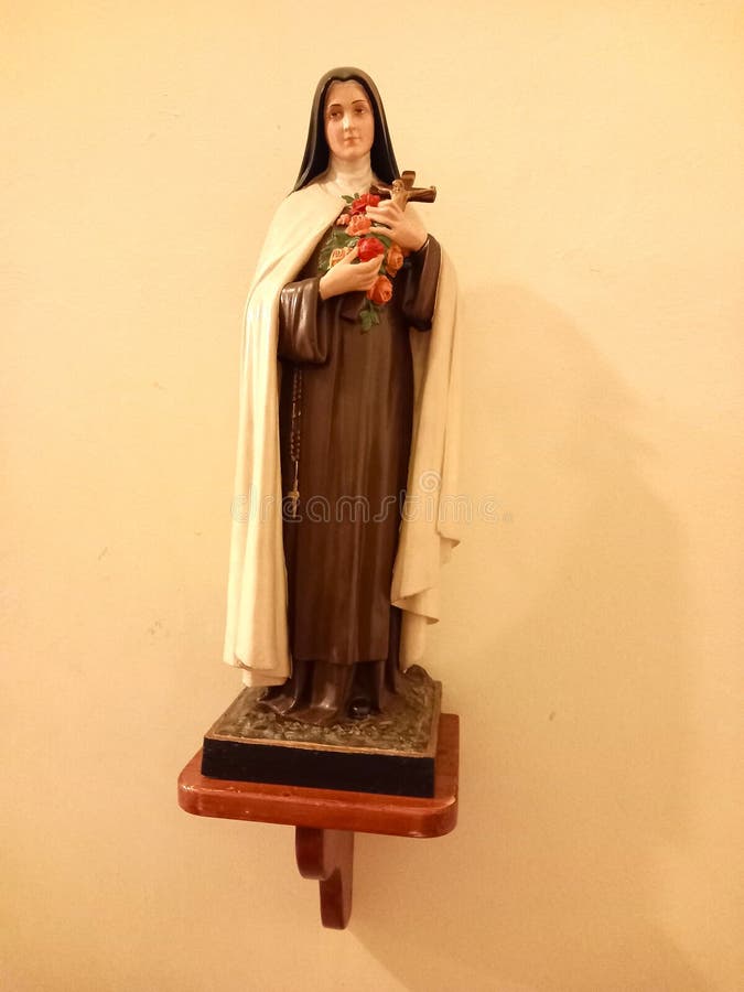 Statue of a Saint Holding a Cross and Roses Stock Illustration ...