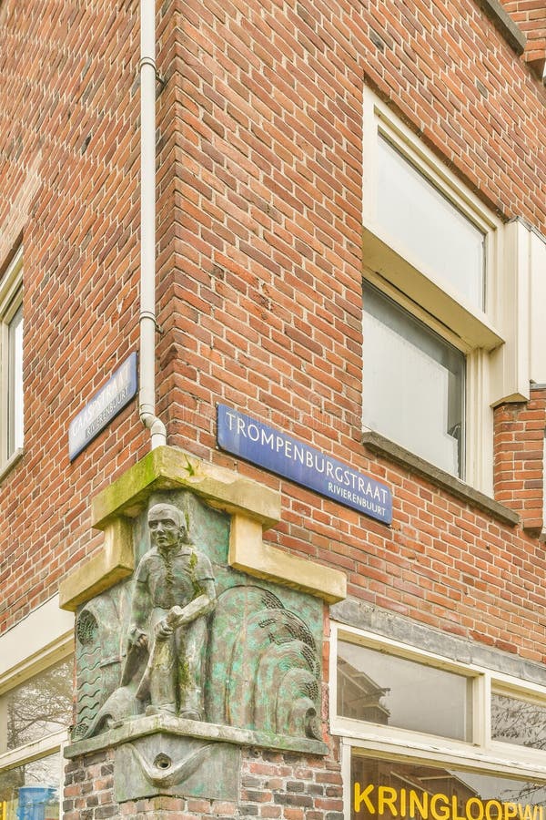 A Statue on the Side of a Brick Building Editorial Stock Photo - Image ...