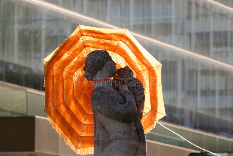 Statue and umbrella stock photo. Image of grey, umbrella - 67405072